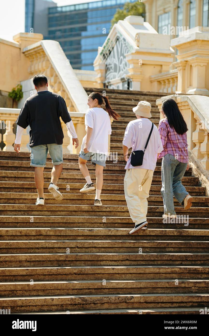 Back of young couple walking up stairs hi-res stock photography and ...