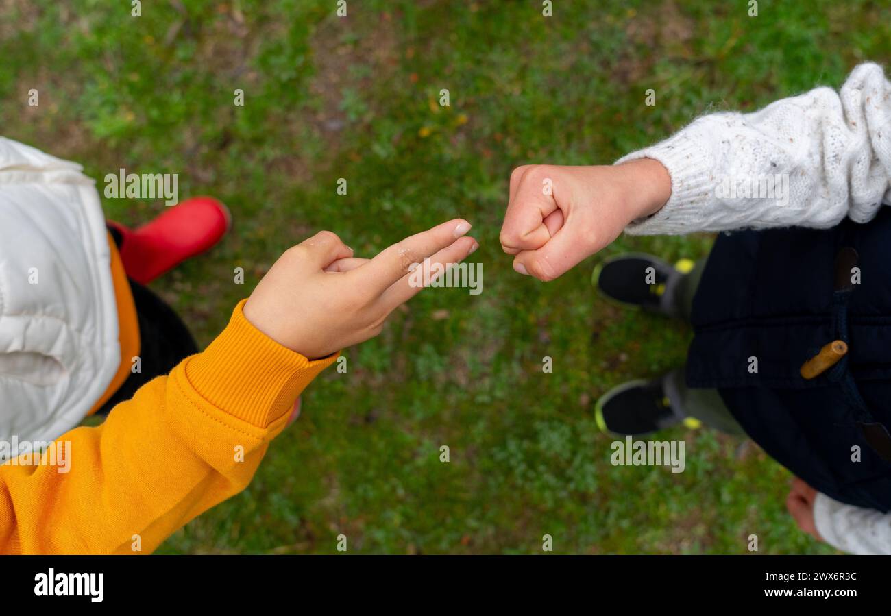 Children playing rock paper scissors Stock Photo - Alamy