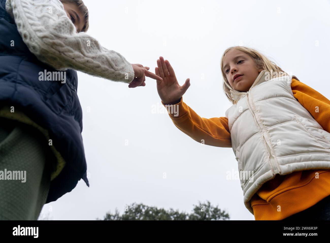 Children playing rock paper scissors Stock Photo - Alamy