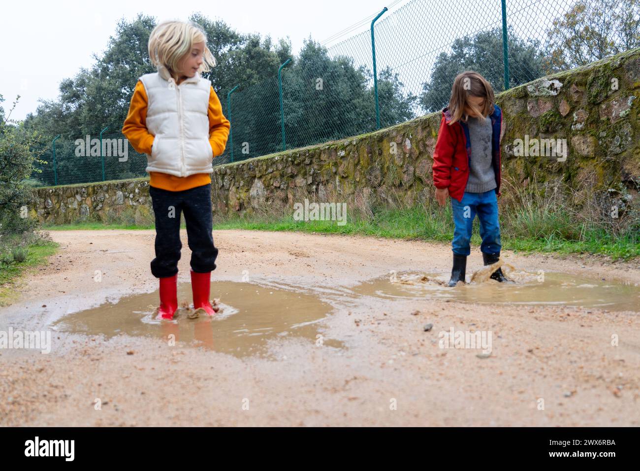 Kids jumping puddle hi-res stock photography and images - Alamy