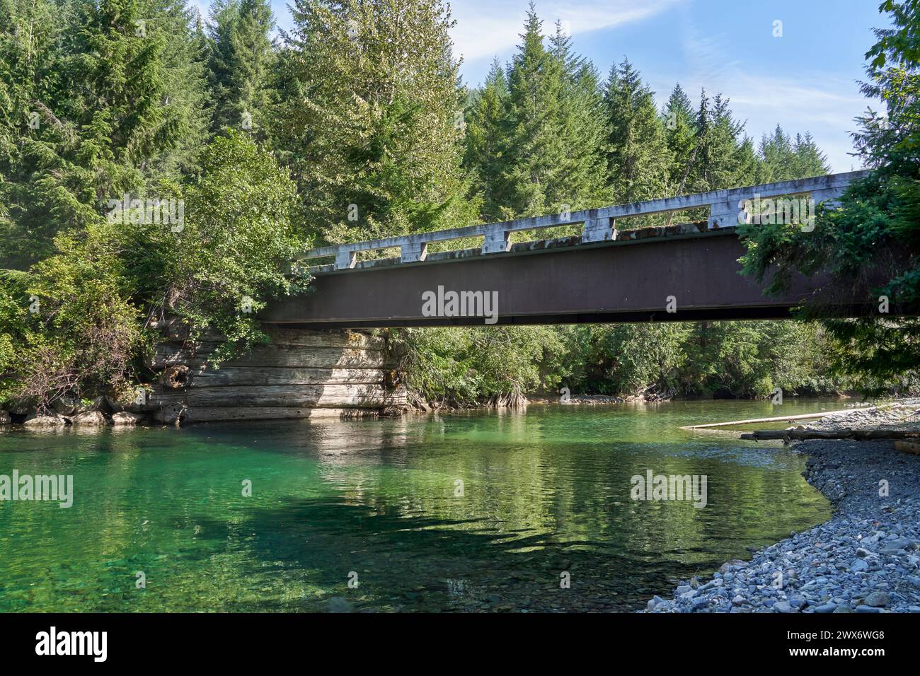 A remote single lane logging road bridge and its reflection in the ...