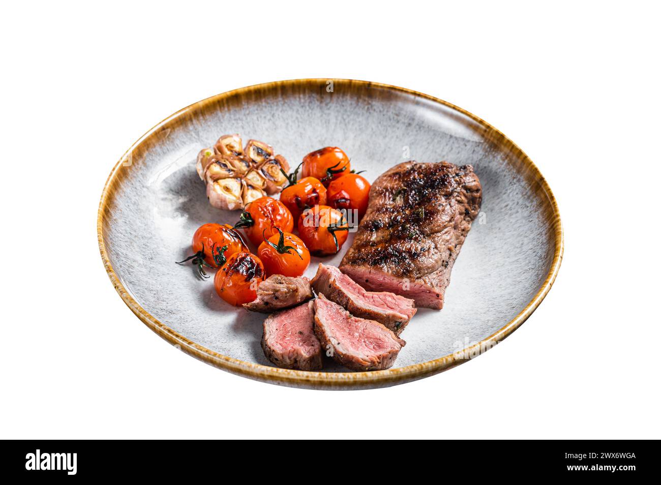 Roasted Lamb tenderloin meat in plate with grilled tomato and garlic ...