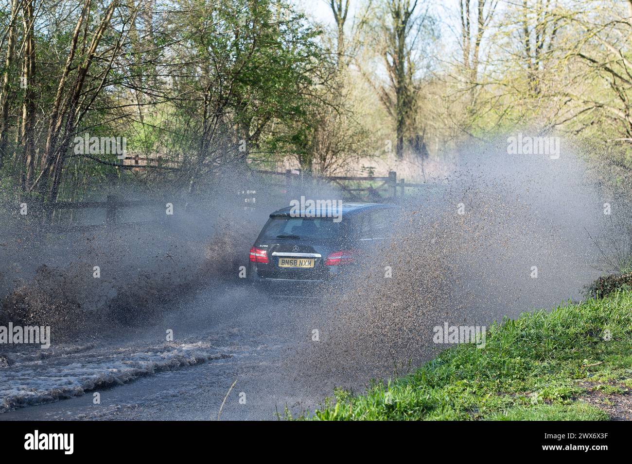 Eton, Windsor, Berkshire, UK. 28th March, 2024. Vehicles splash through ...