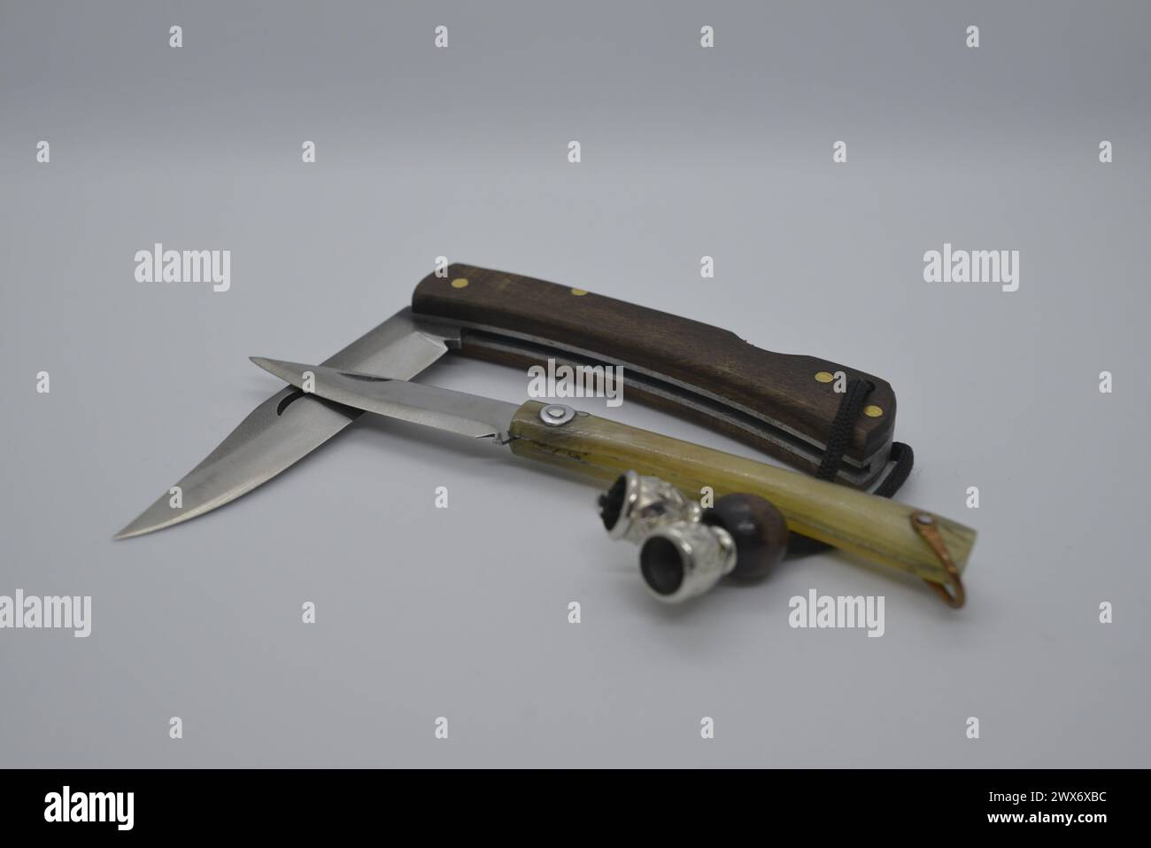 Open pocketknives displayed against a white background, revealing their ...