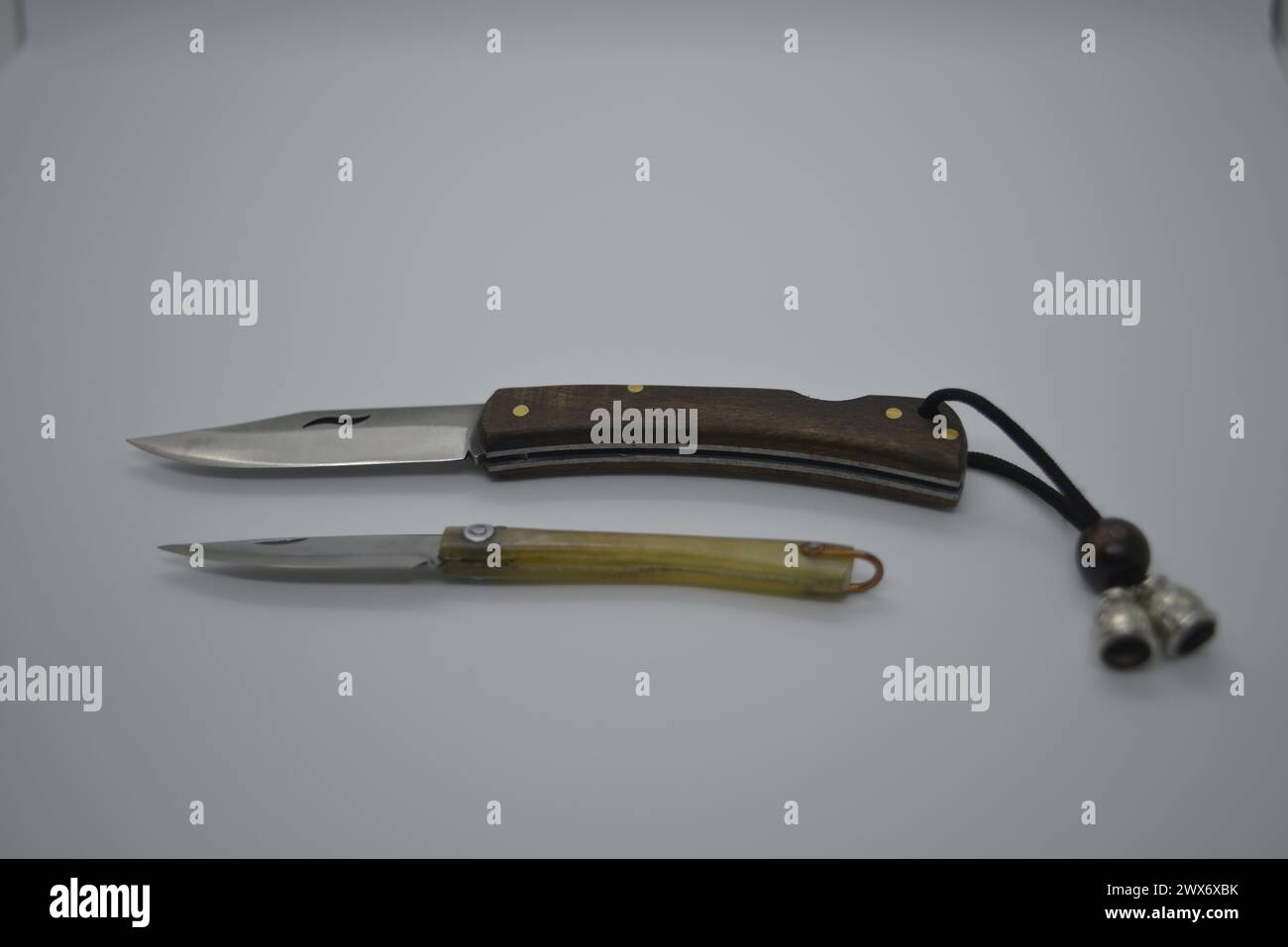 Open pocketknives displayed against a white background, revealing their ...
