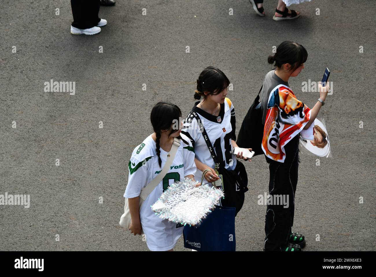 fans in Tokyo in front of singer poster Stock Photo - Alamy
