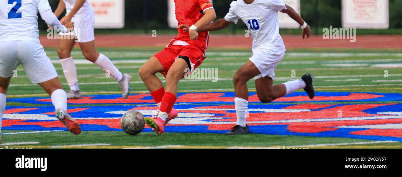 Horizontal view of many soccer players fighting for the soccer ball ...