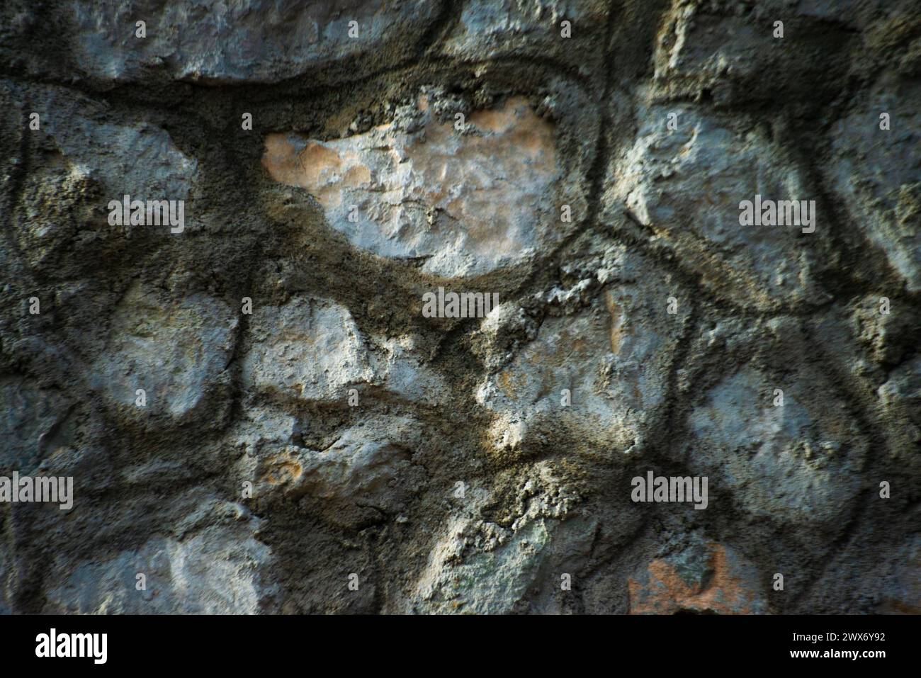 An ancient stone wall stands as a timeless monument, weathered and moss ...