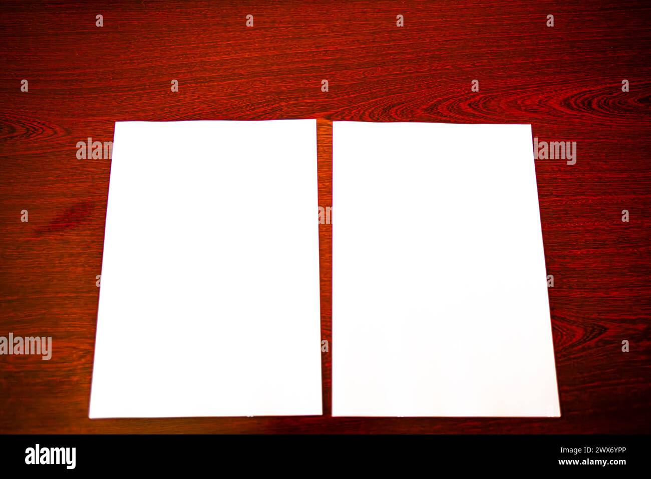 A pristine desk adorned with neatly stacked white A4 papers, creating ...