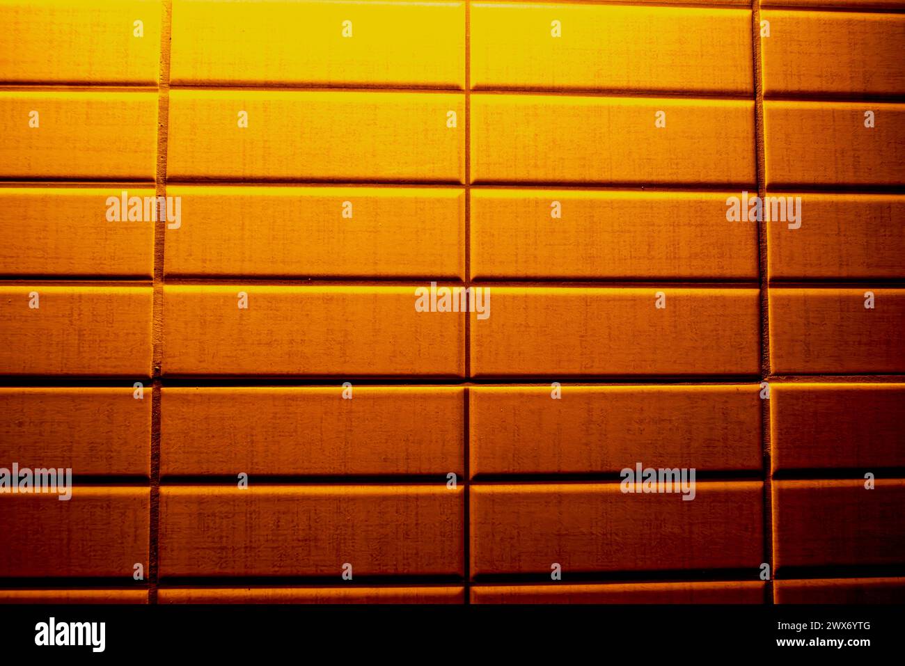 An ambient night glow transforms a brick wall into an illuminated ...