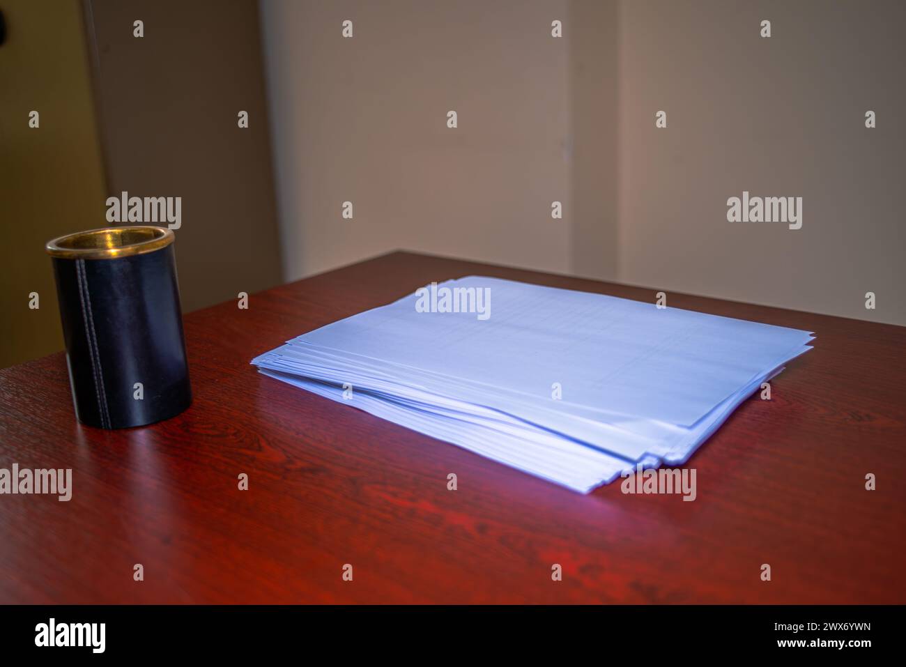 A pencil box and a bunch of A4 papers create an organized and ...