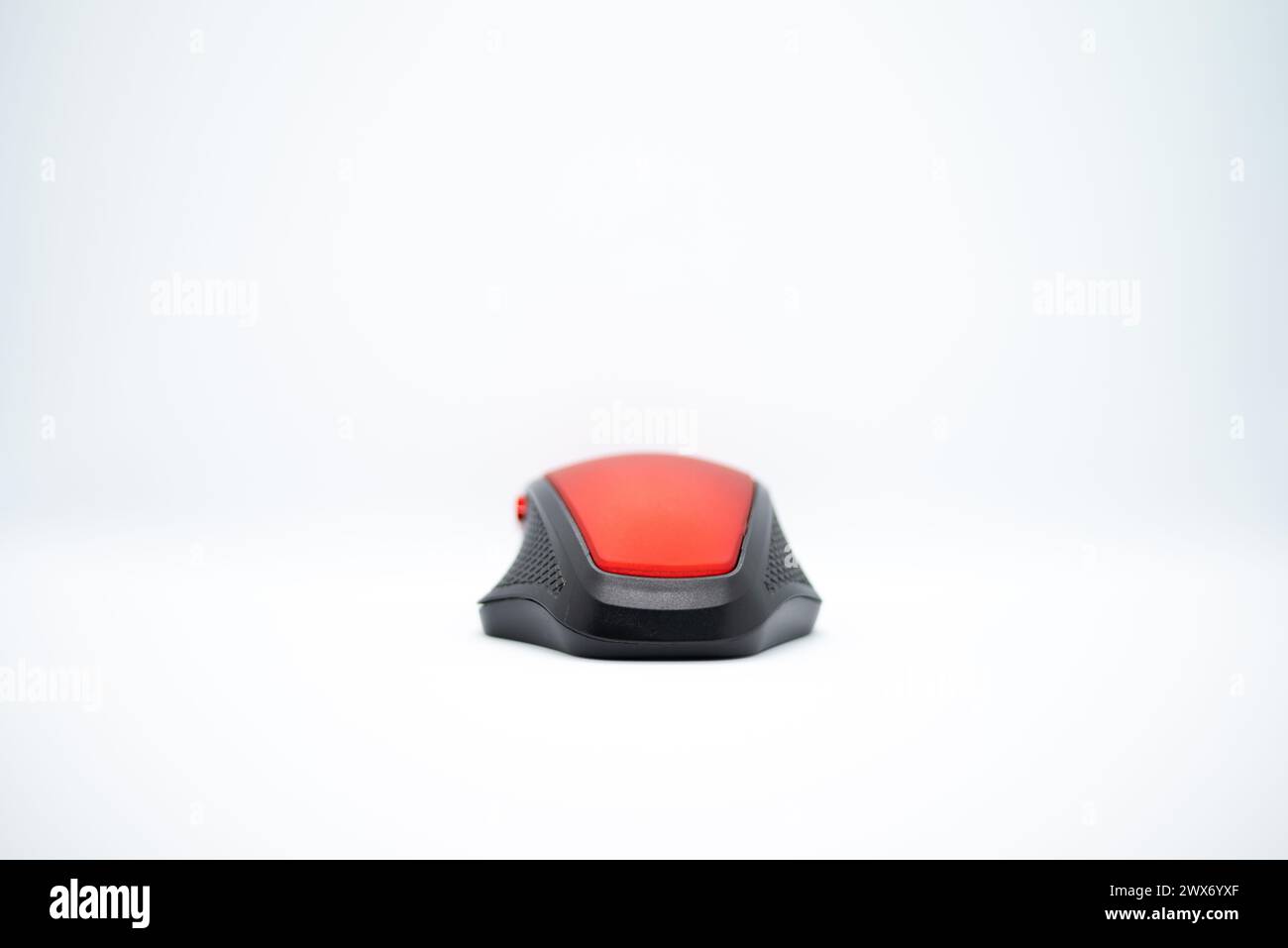 A sleek red mouse on a clean white background, blending style with ...