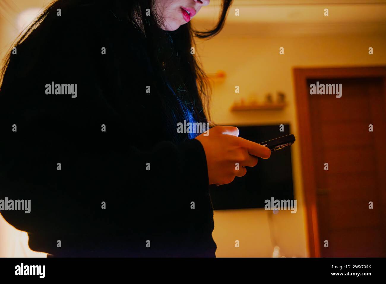 Woman holding mobile athome hi-res stock photography and images - Alamy