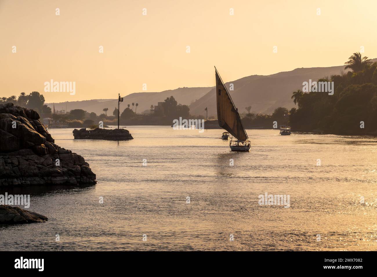 Felucca (traditinal egyptian sailing boat) on the Nile river at sunset ...