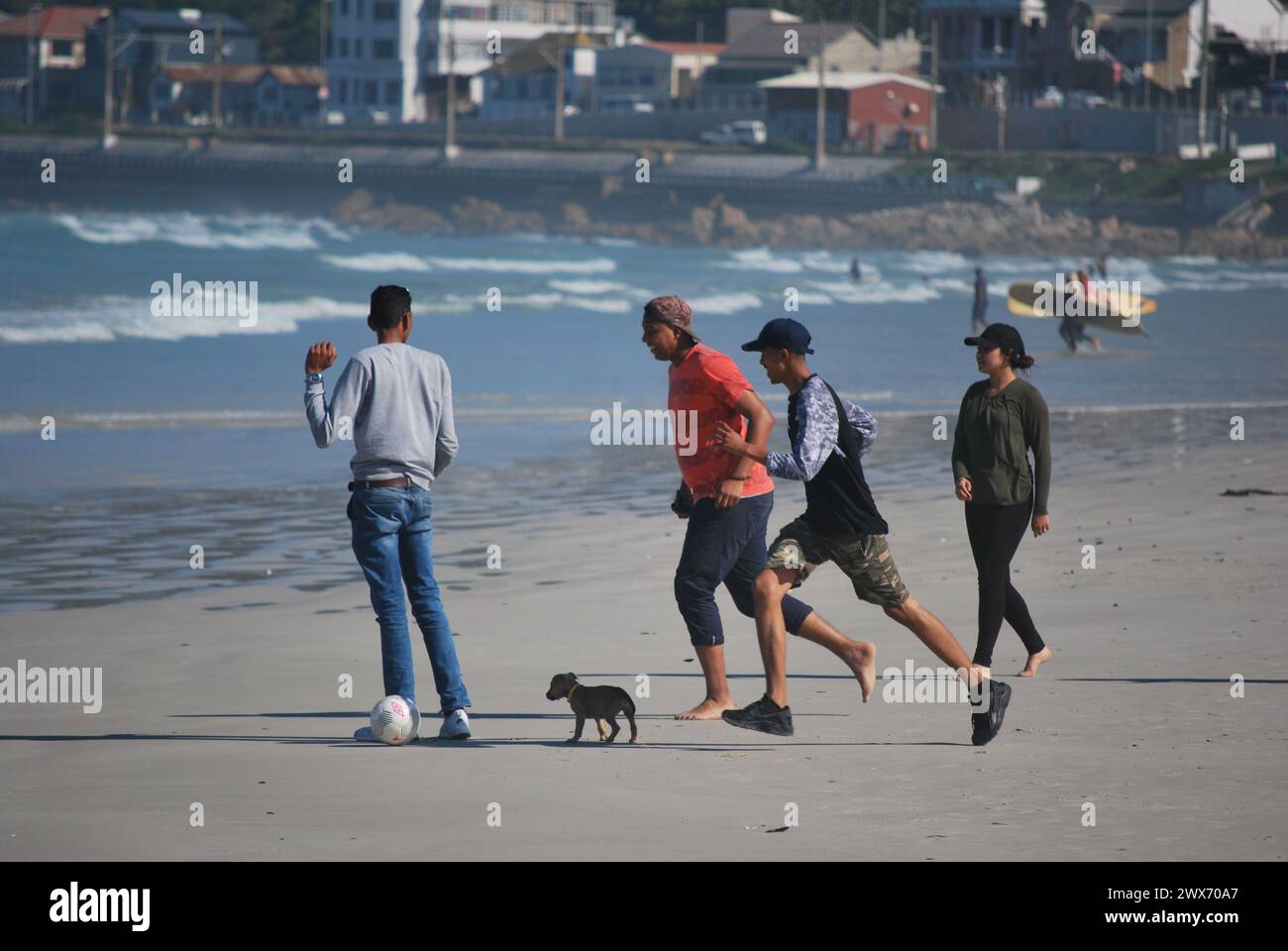 young people on muizenberg beach play football Stock Photo - Alamy