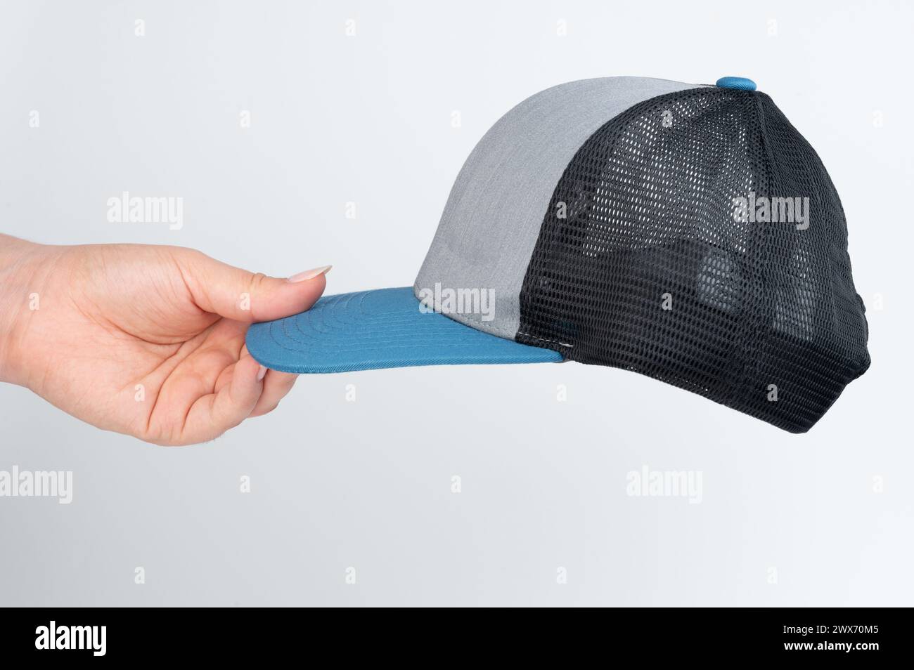 Hand hold blue cap side view isolated close up view Stock Photo - Alamy