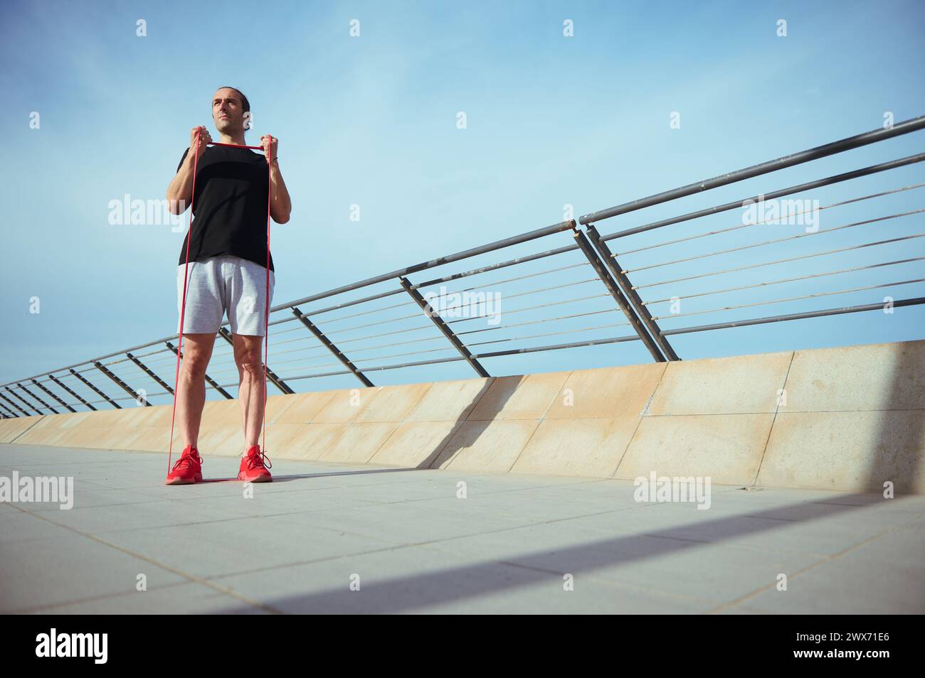Full length portrait of active young man with athletic body performs ...