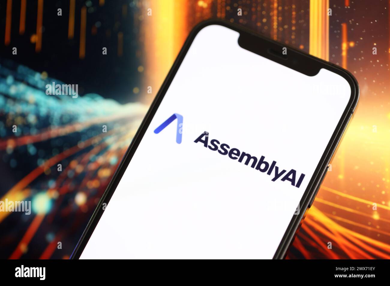 KYIV, UKRAINE - MARCH 17, 2024 AssemblyAI logo on iPhone display screen with background of ...
