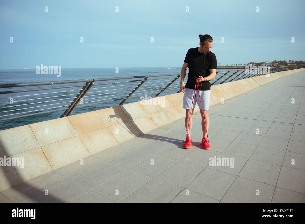 Full length shot of a man with athletic body doing exercises on arms ...