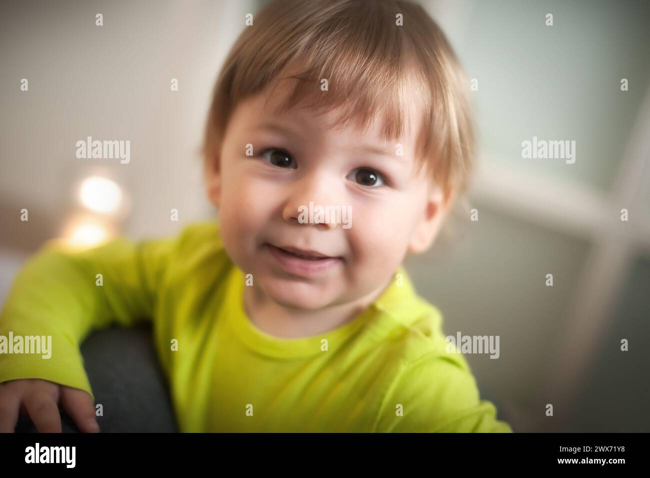 Beaming smile of happy cute toddler in a cozy home setting at playtime ...