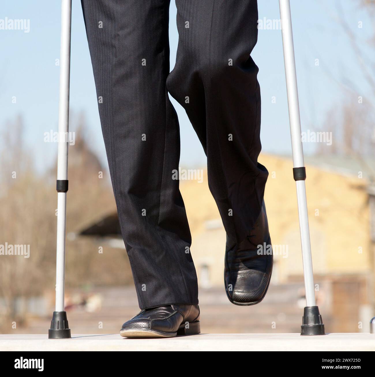 Disabled man on crutches woman hi-res stock photography and images - Alamy
