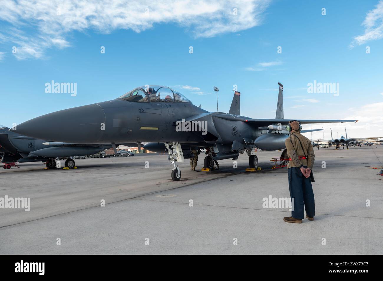 U.S. Air Force Airman guides F-15E Strike Eagle pilots as they return ...