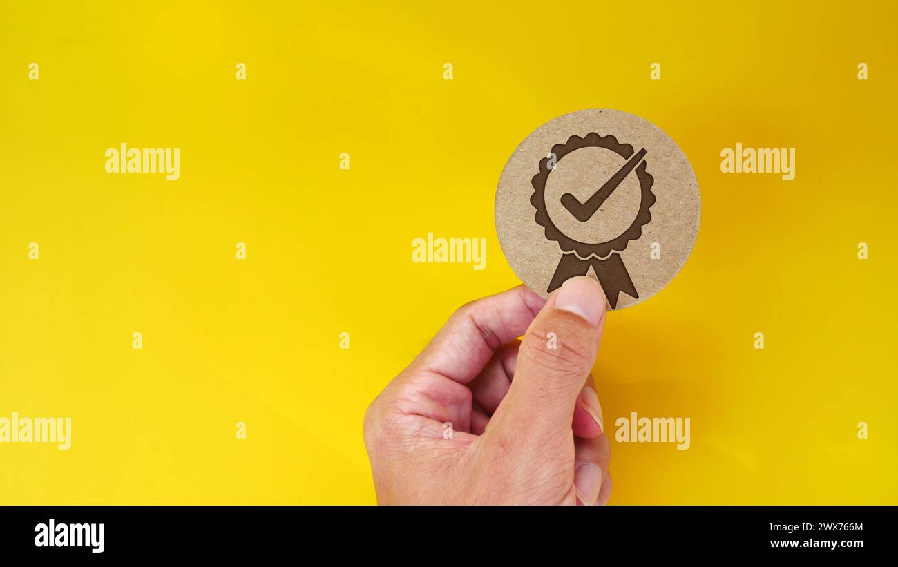 Quality assurance concept. Businessman hand holding card with quality ...