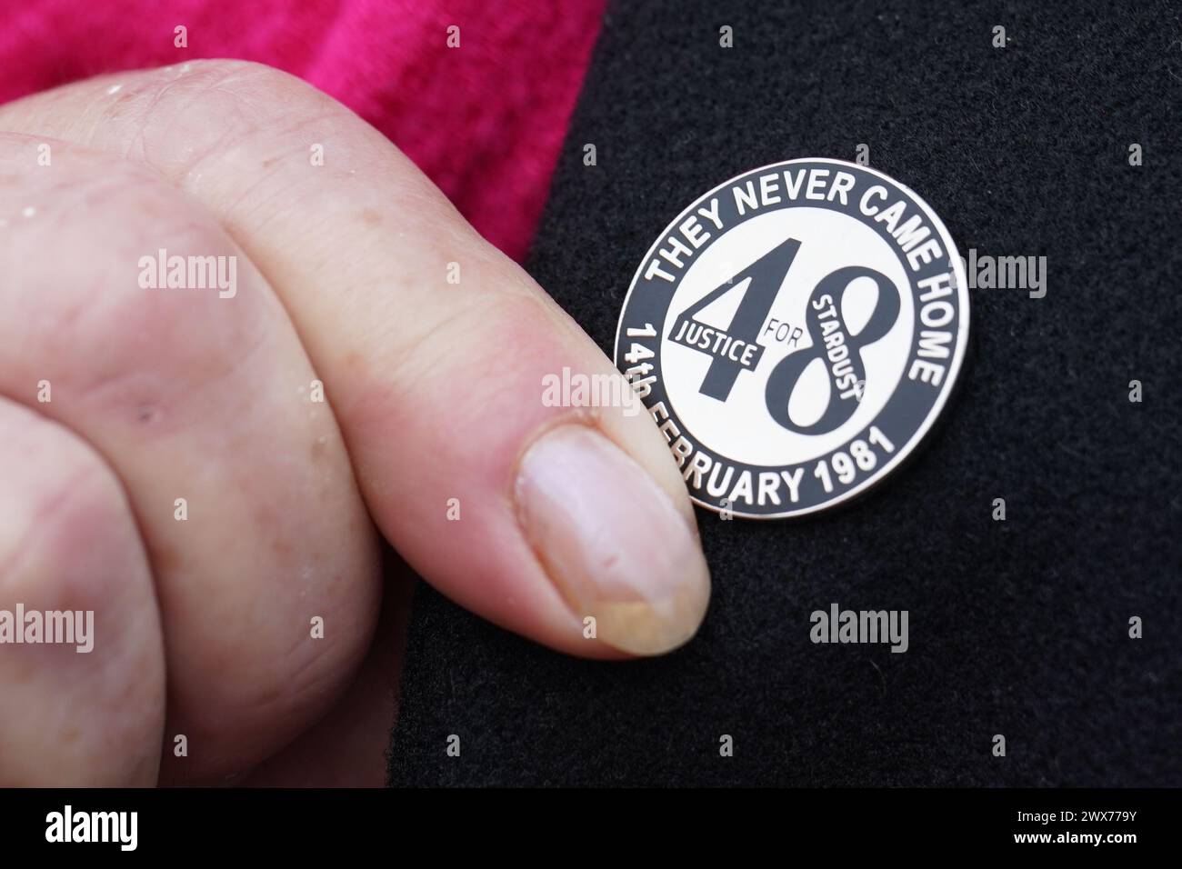 A family member touches her Stardust lapel pin on gher way into Dublin ...