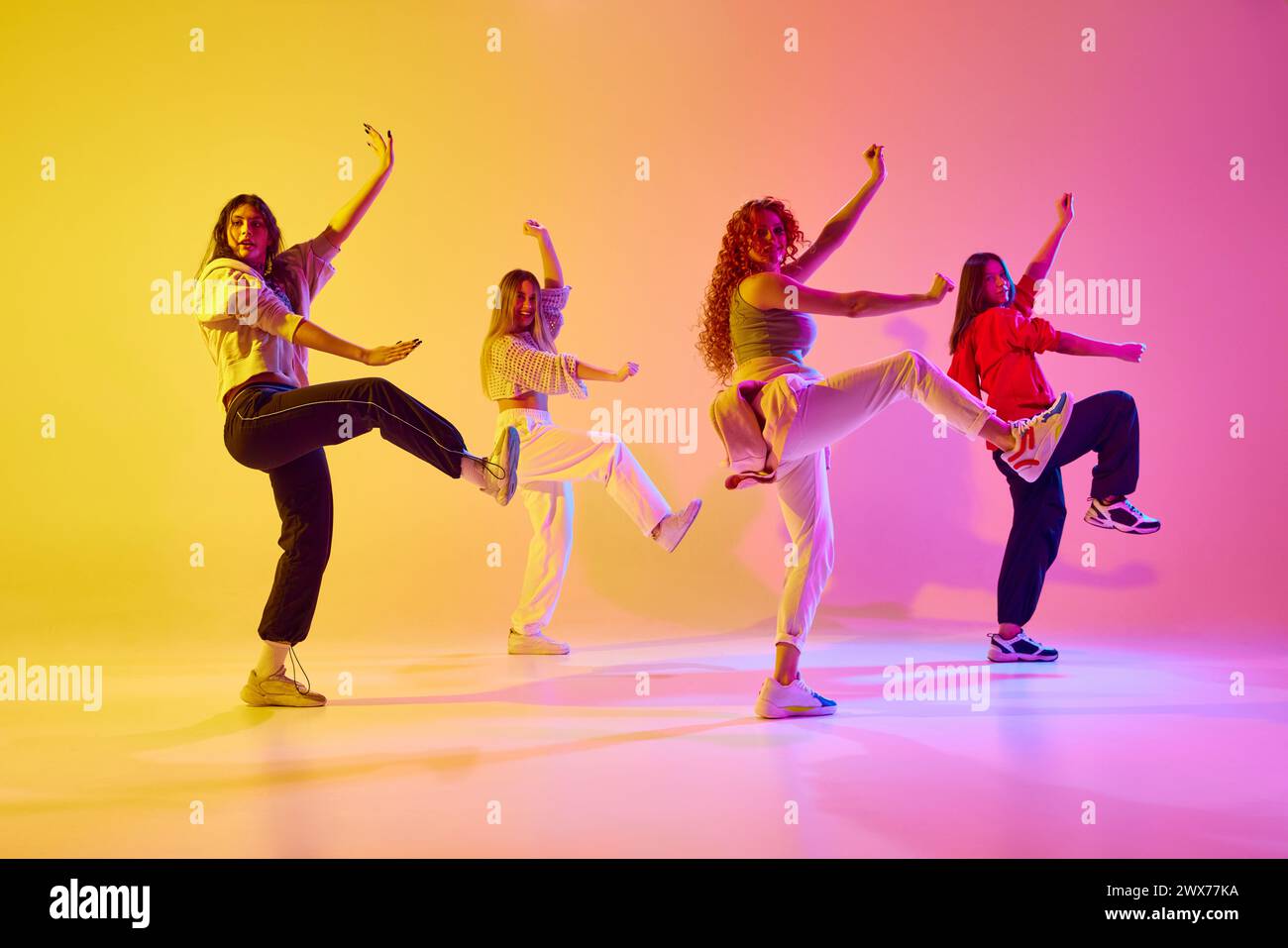 Dynamic image of young people, female dancers in motion dancing modern ...
