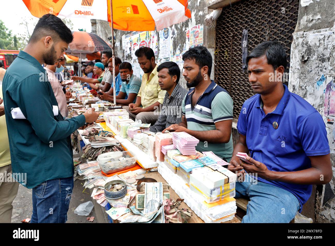 Dhaka, Bangladesh - March 28, 2024: Vendors are seen selling new money ...