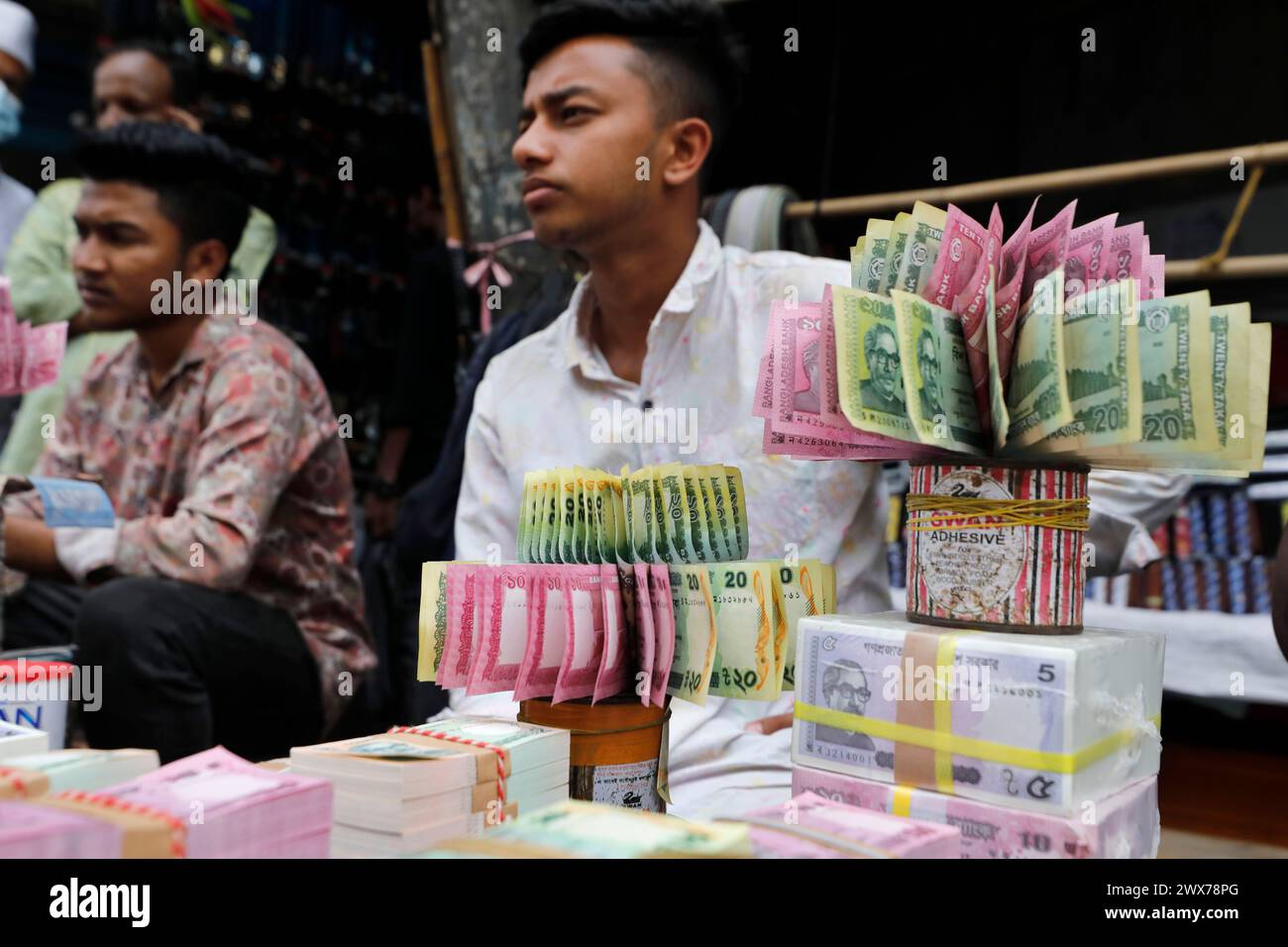 Dhaka, Bangladesh - March 28, 2024: Vendors are seen selling new money ...