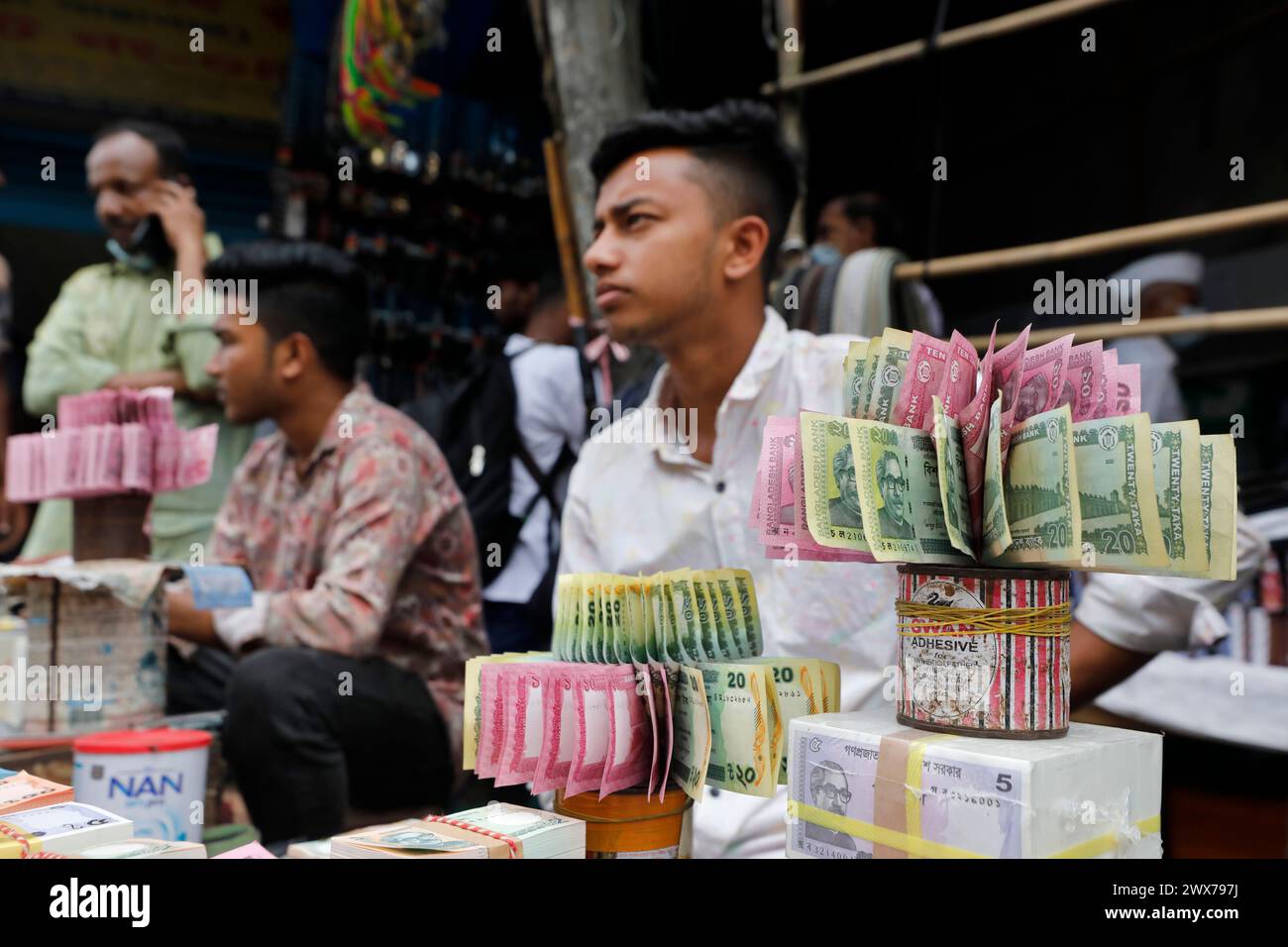 Dhaka, Bangladesh - March 28, 2024: Vendors are seen selling new money ...