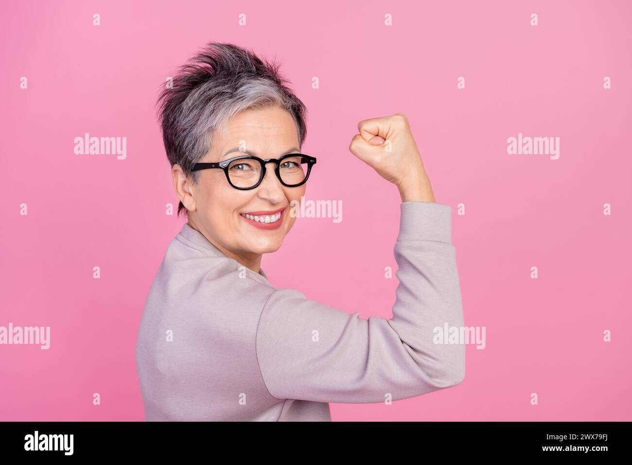 Photo of cheerful positive strong woman showing arm biceps sport gym ...