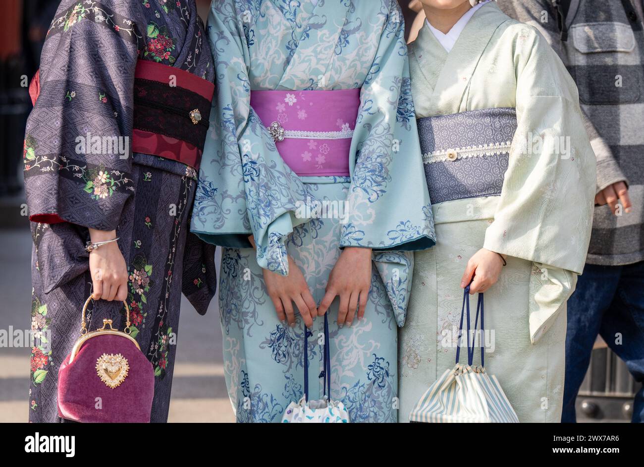 Young girl wearing Japanese kimono standing in front of Sensoji Temple ...