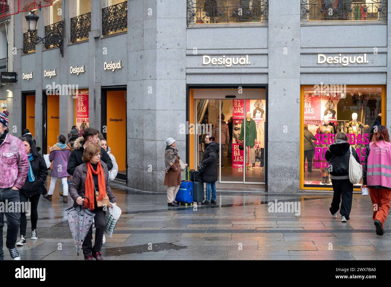Pedestrians walk past the Spanish clothing brand Desigual store in ...
