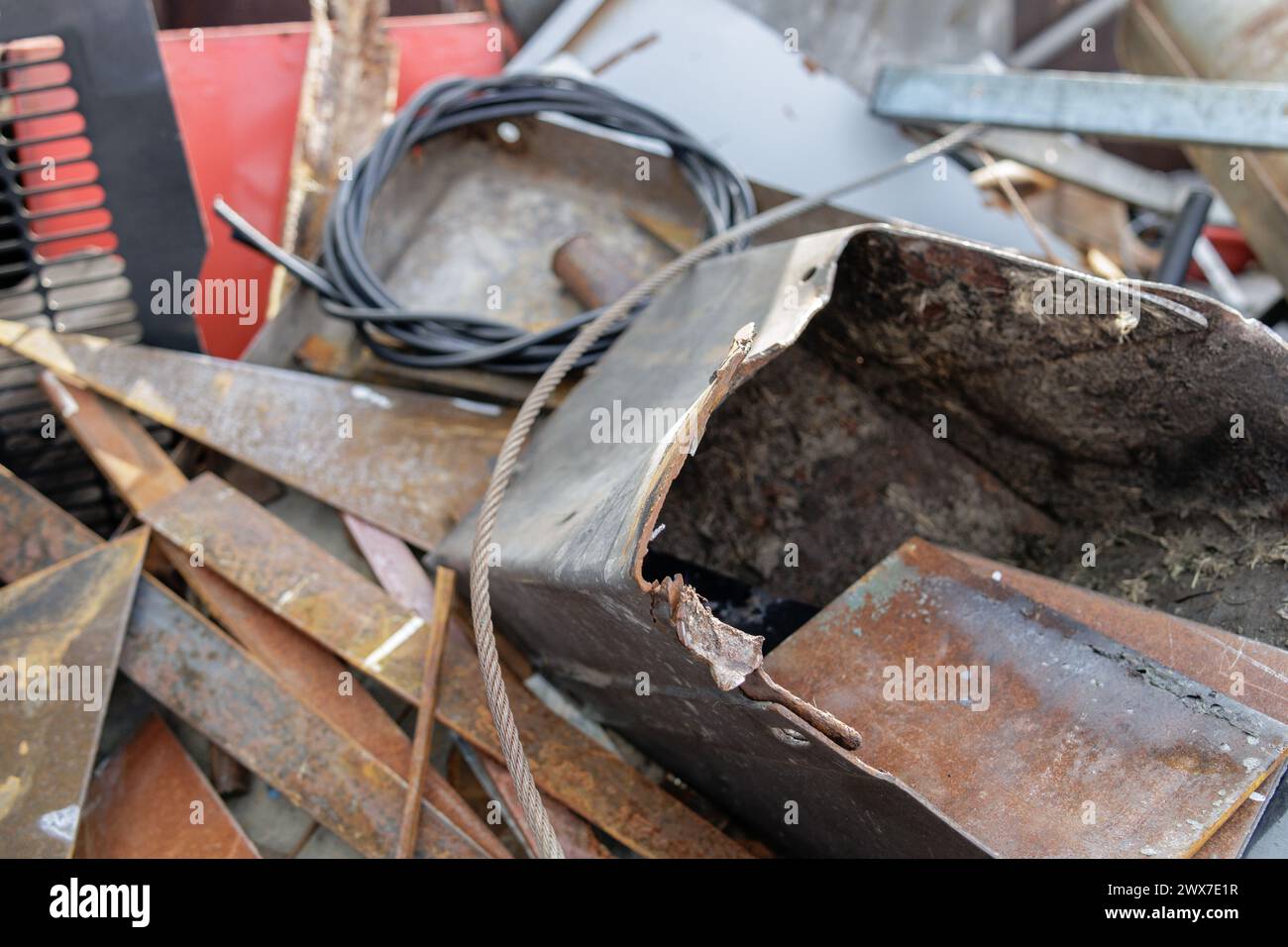 In a close-up photograph, abandoned metal waste litters a scrap yard ...