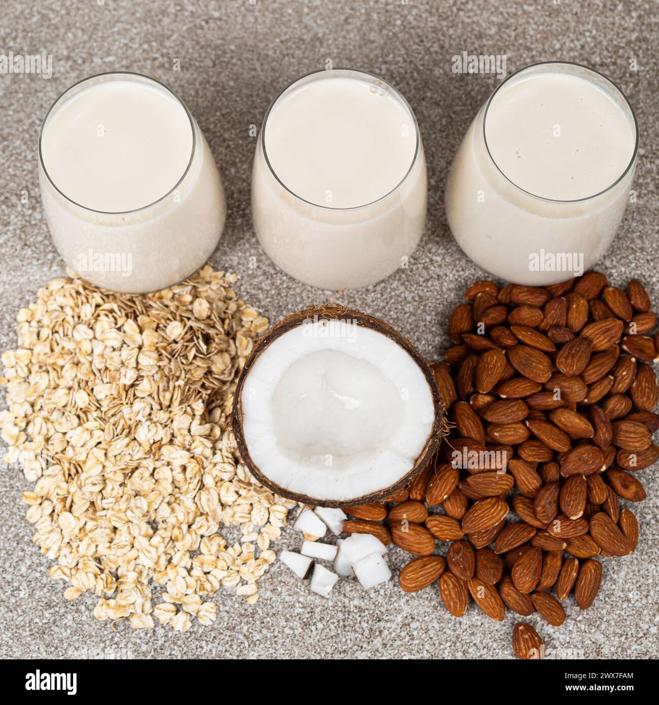 Types of plant-based milk in glasses. Oat, coconut and almond milk ...