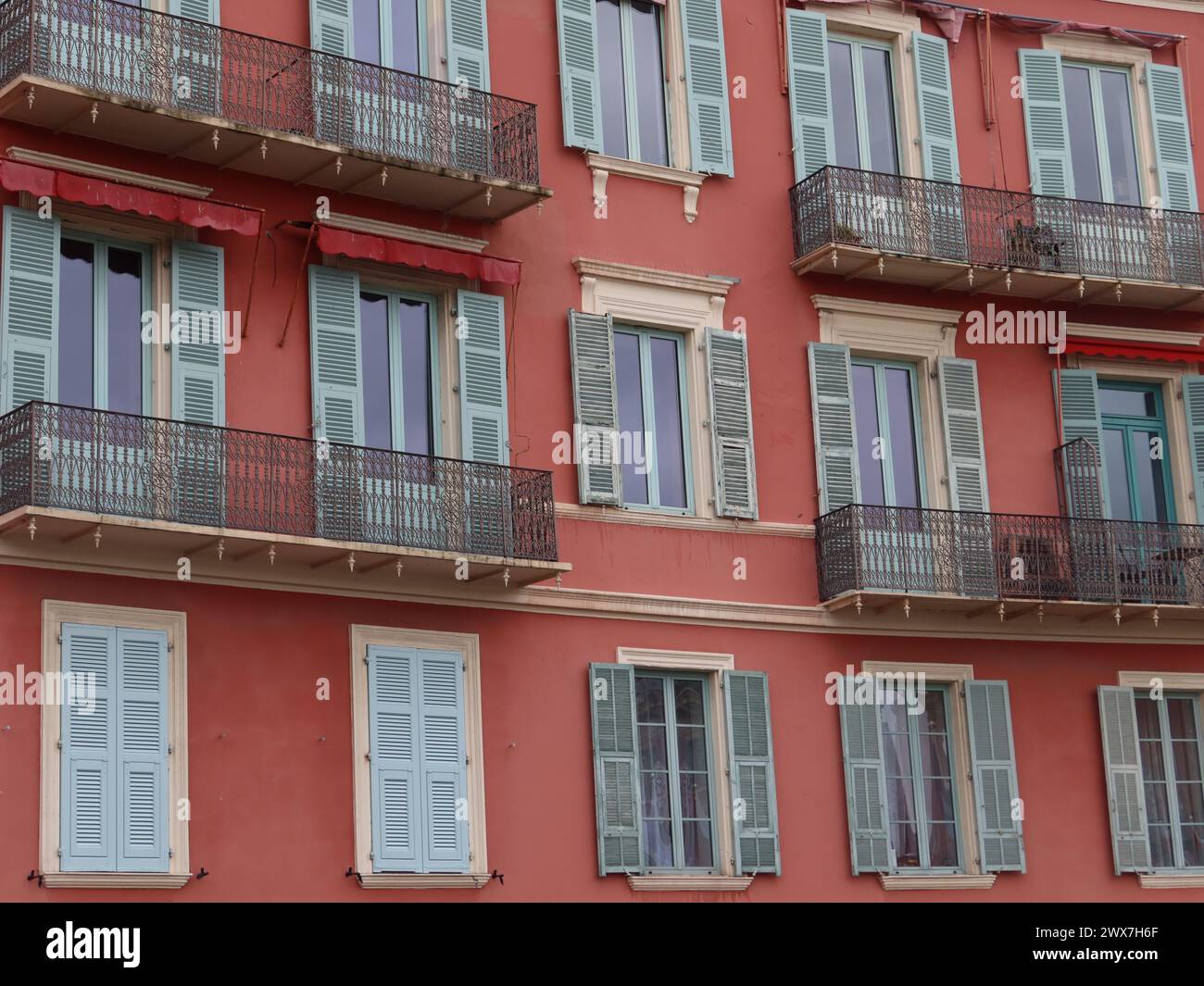 Tall windows, shutters, balconies & coloured render are the features of ...