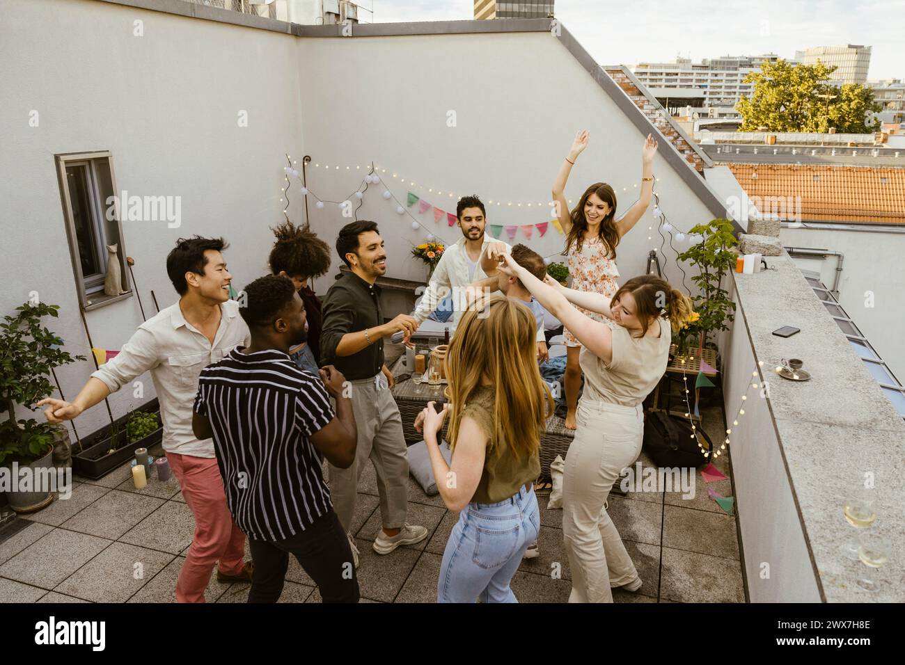 High angle view of multiracial male and female friends dancing in ...