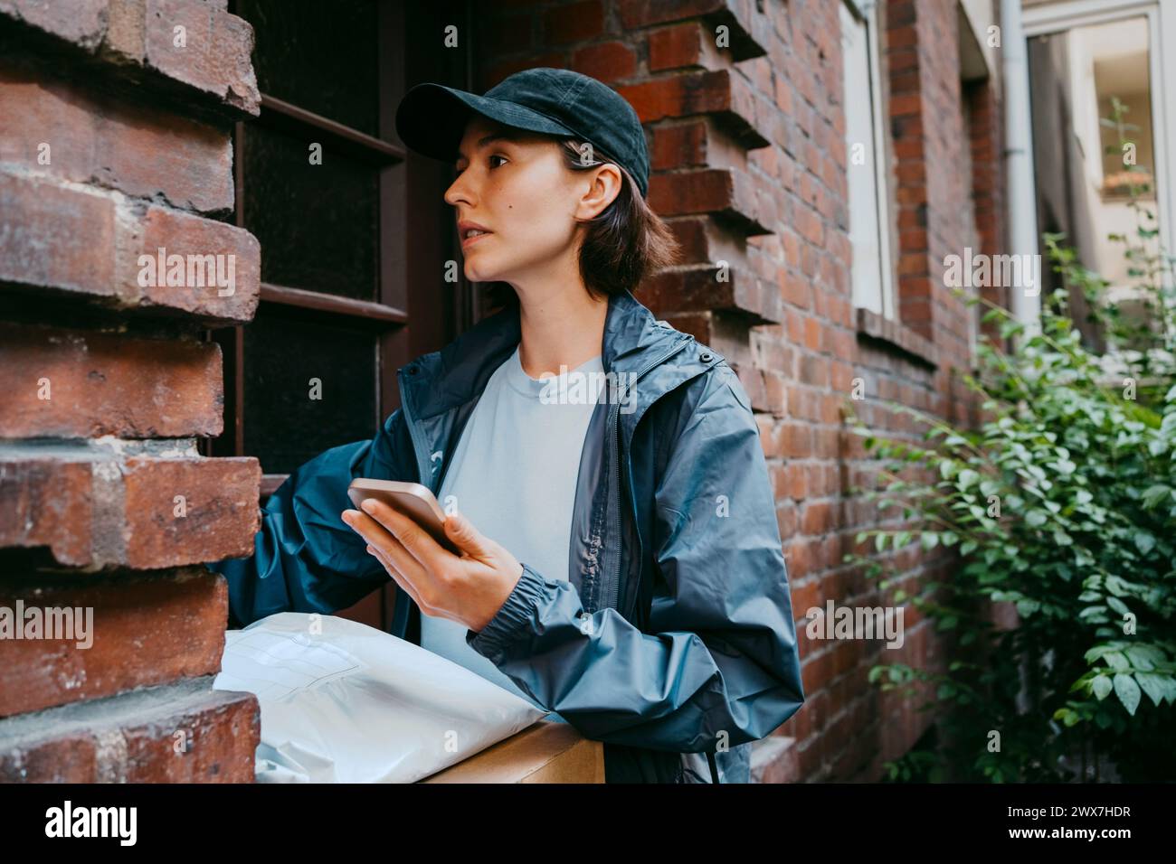Courier delivering package female customer hi-res stock photography and ...