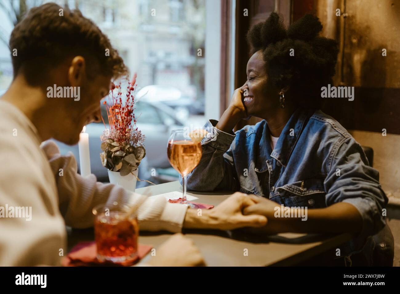 Boyfriend holding hand and flirting with girlfriend during date at ...