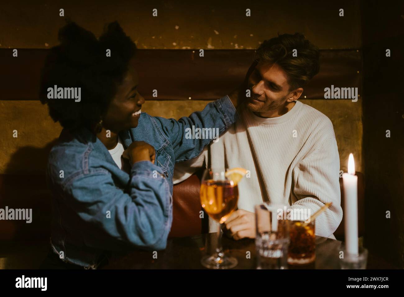 Romantic woman caressing boyfriend while sitting at restaurant Stock ...