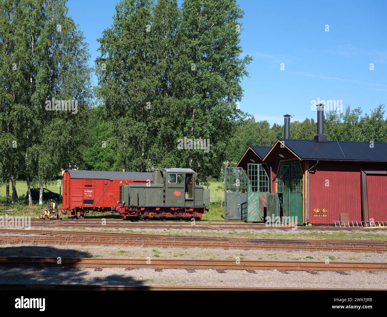 View of an outdoor railroad museum in Sweden. Rail road tracks, a ...