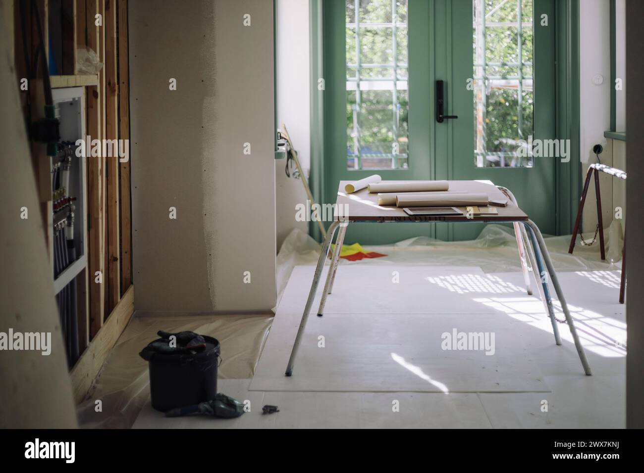 Blueprints over table at under construction apartment Stock Photo - Alamy