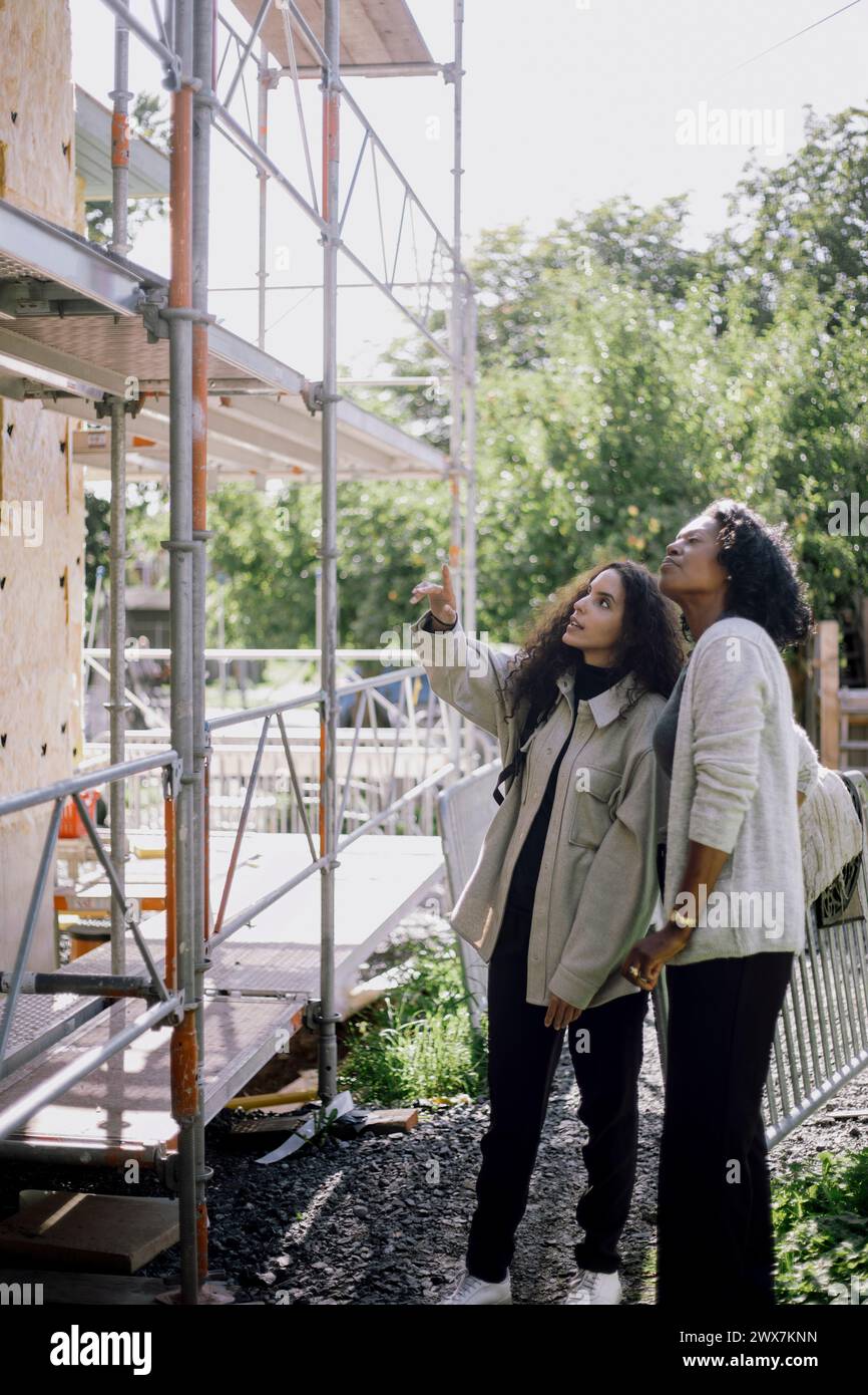 Female architect showing under construction apartment to customer Stock ...