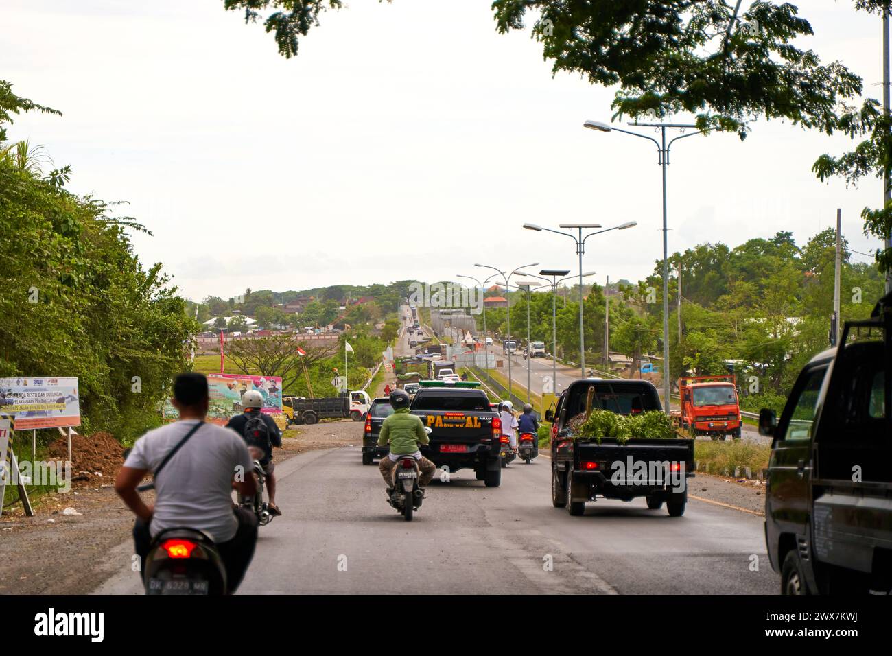 Asphalt roads and traffic with cars and motorcycles on the island of ...