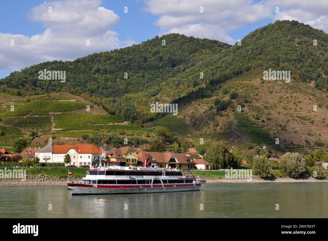 A river cruise ship sails past the town of Spitz and its terraced ...