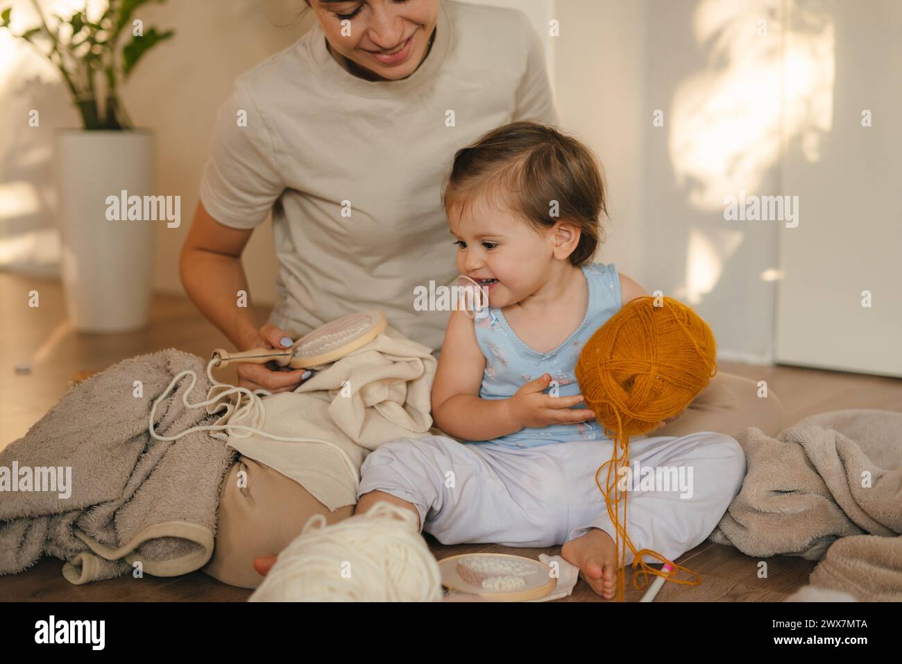 Mom teaching child crafting. Mother and daughter knitting together ...