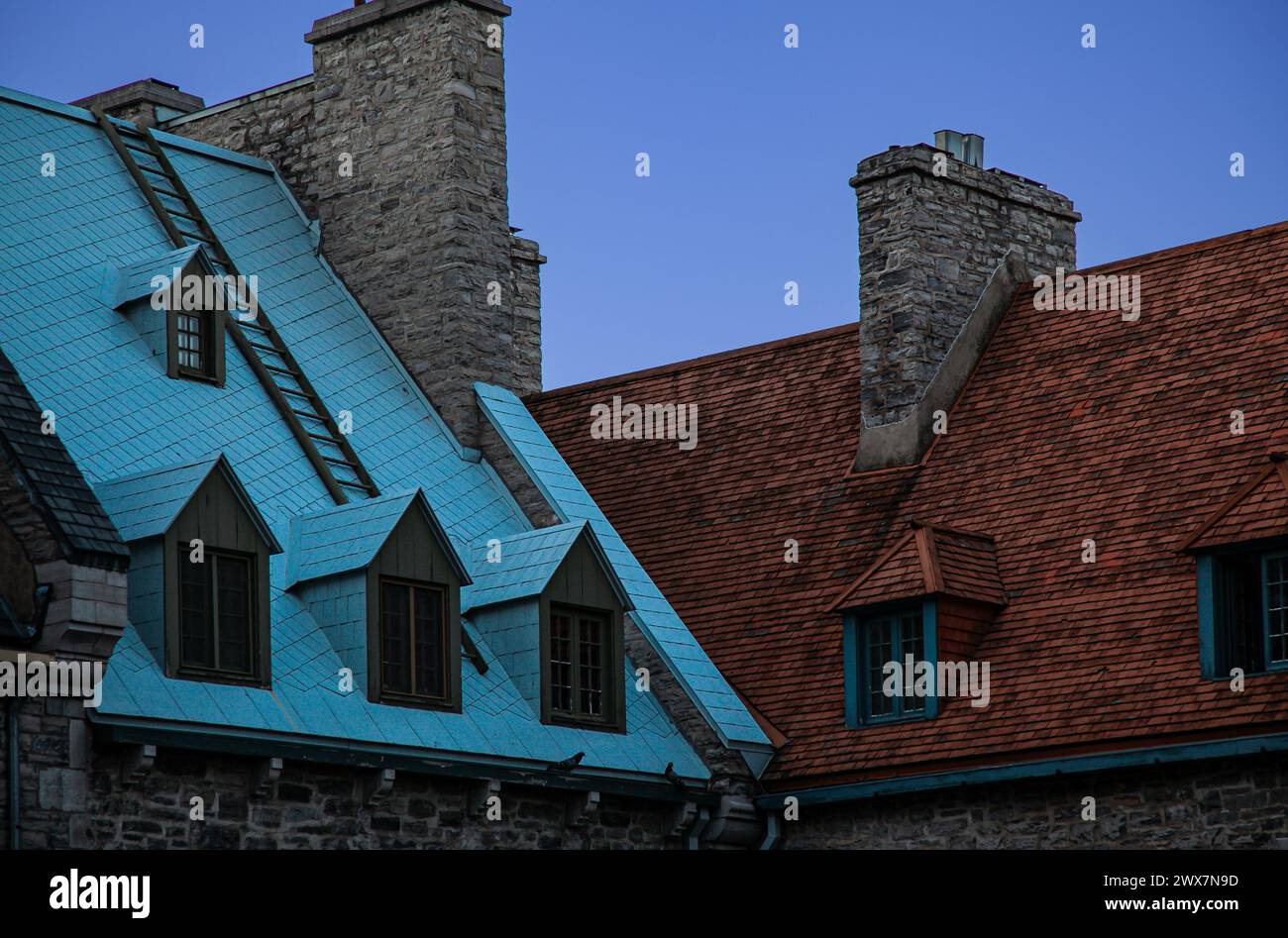 Colorful rooftops with dormer windows and stonework chimneys of ...