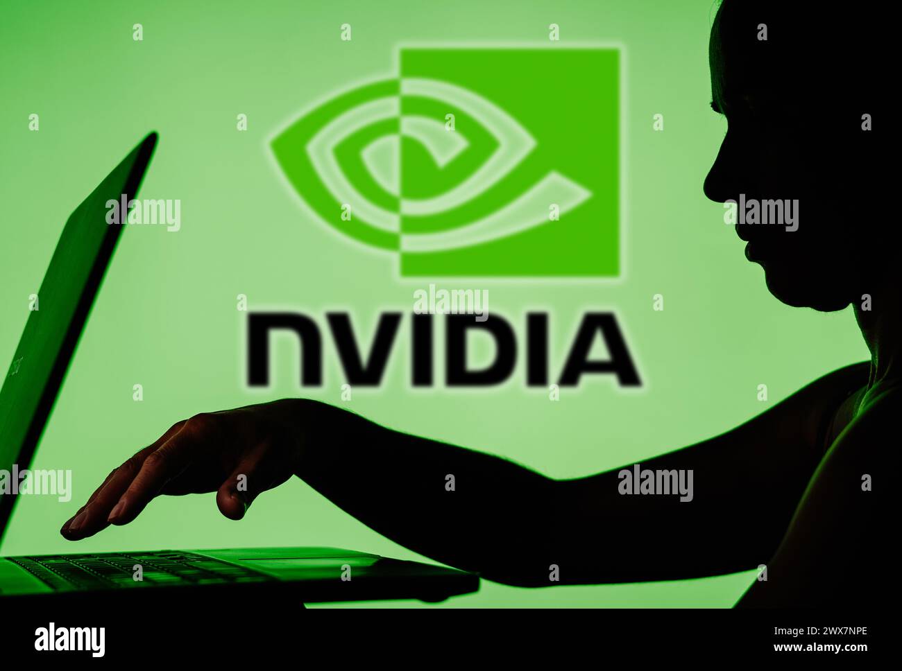 In this photo illustration, the Nvidia logo is seen in the background ...